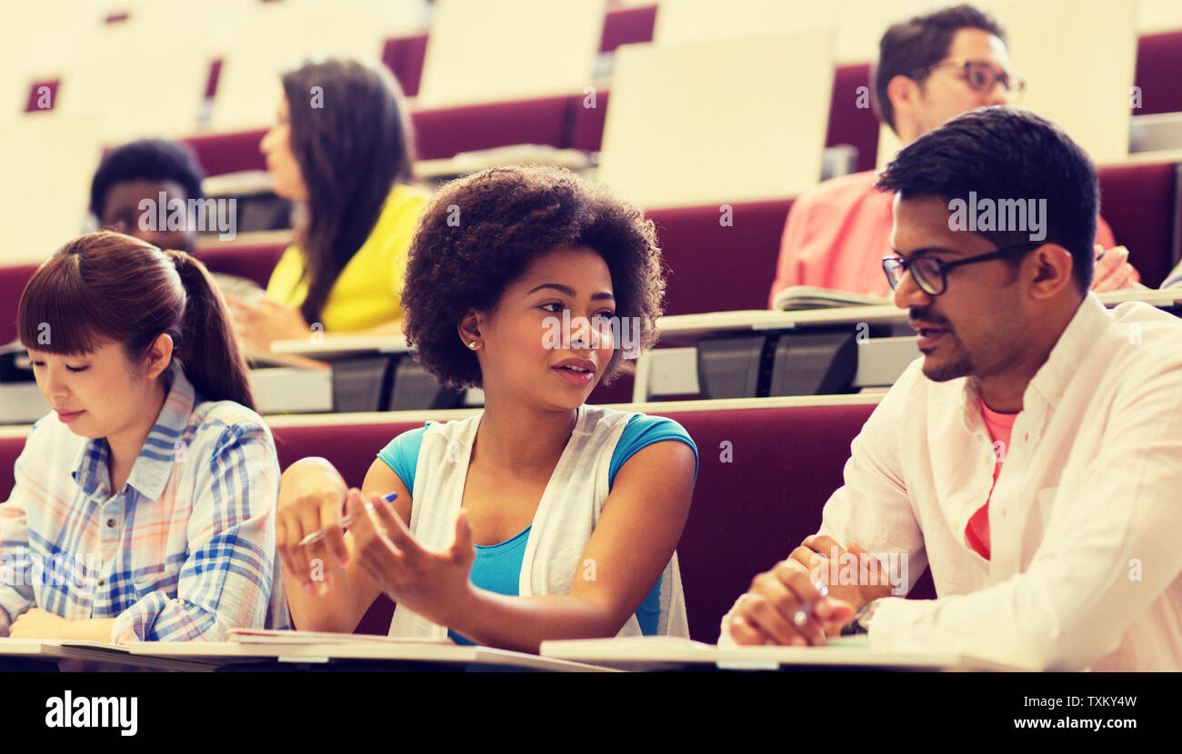 group of students with notebooks in lecture hall Stock Photo - Alamy