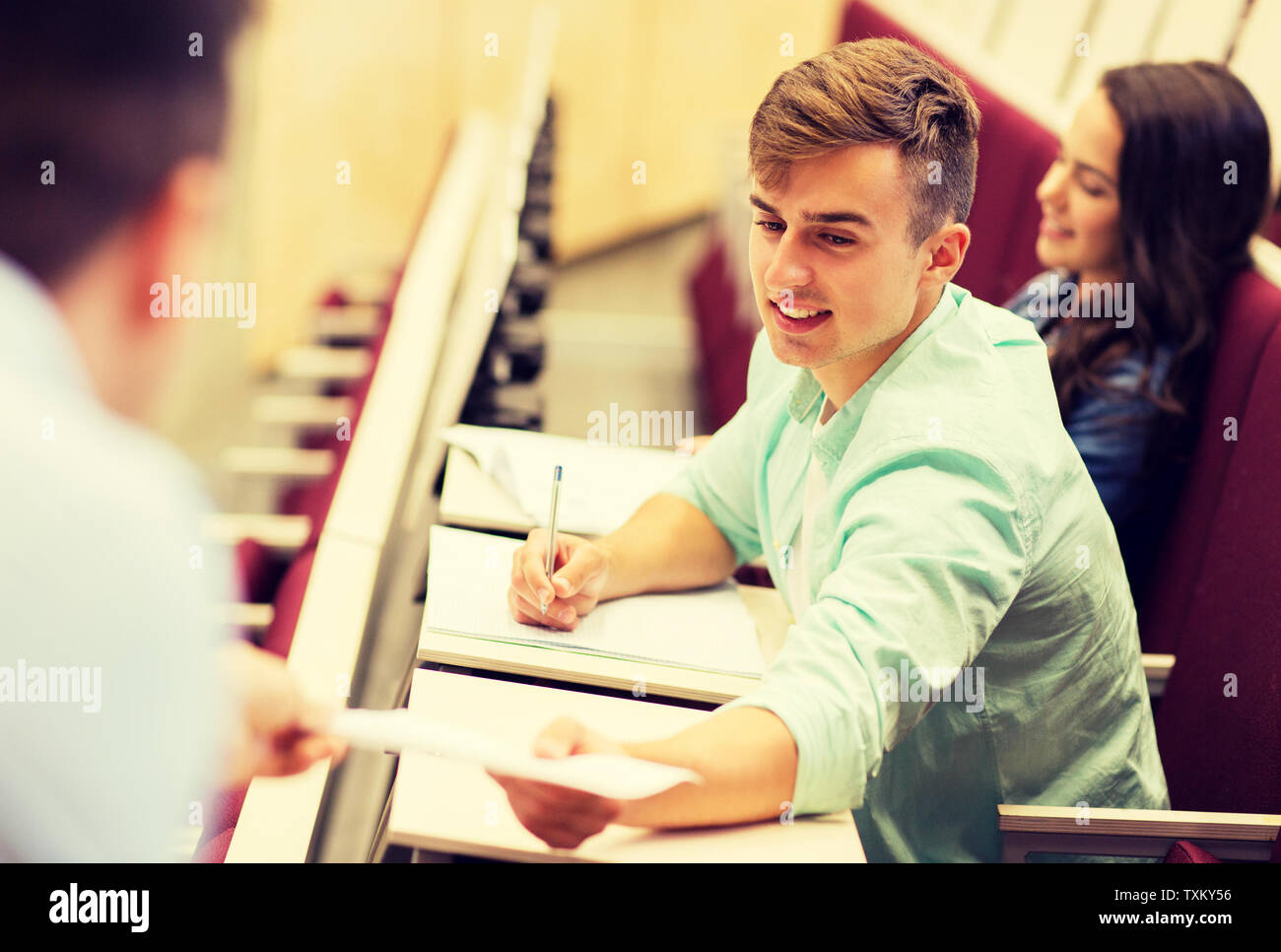 teacher giving test to student boy on lecture Stock Photo - Alamy