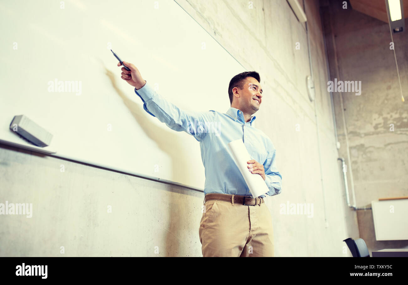teacher pointing marker to white board at lecture Stock Photo - Alamy