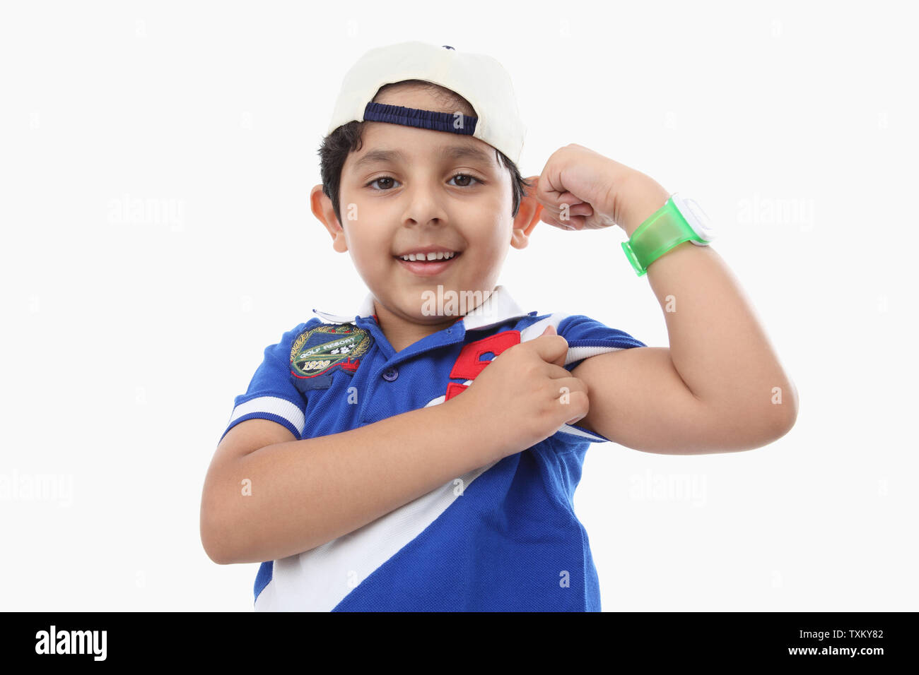 Boy showing his biceps and smiling Stock Photo - Alamy