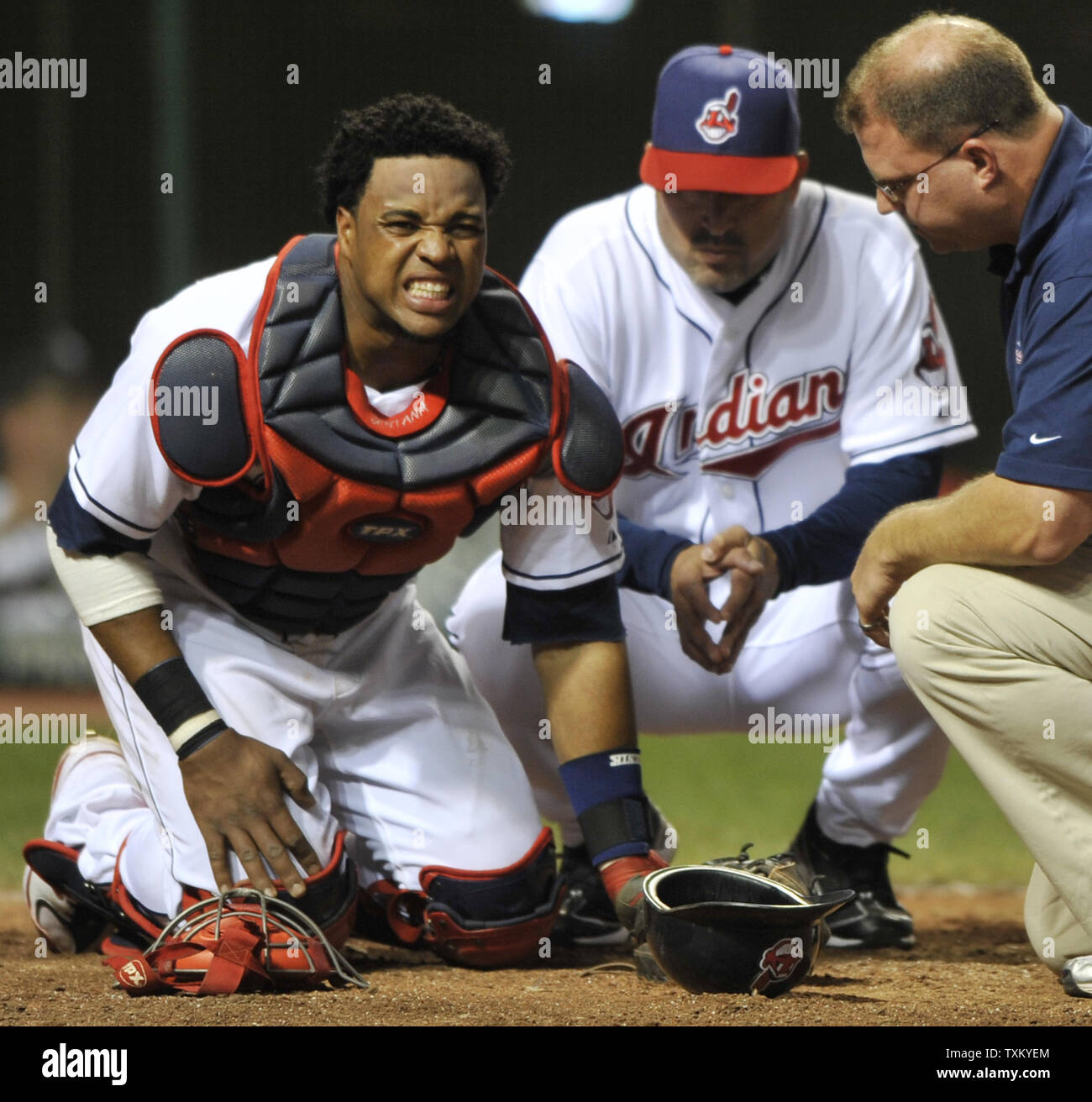 Cleveland Indians catcher Carlos Santana, left, is checked by manager ...