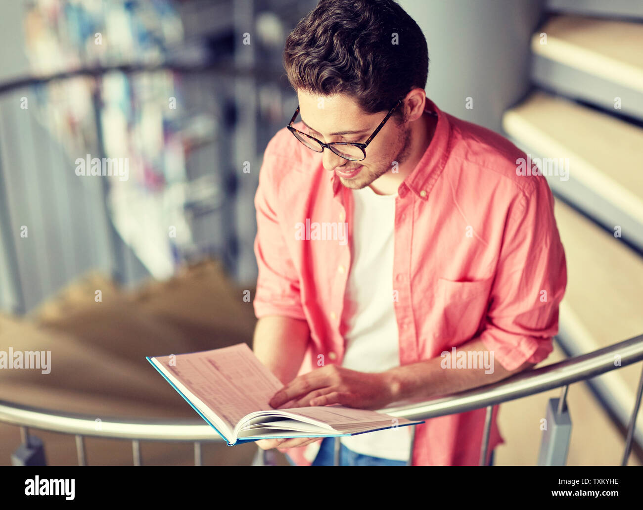 student boy or young man reading book at library Stock Photo - Alamy