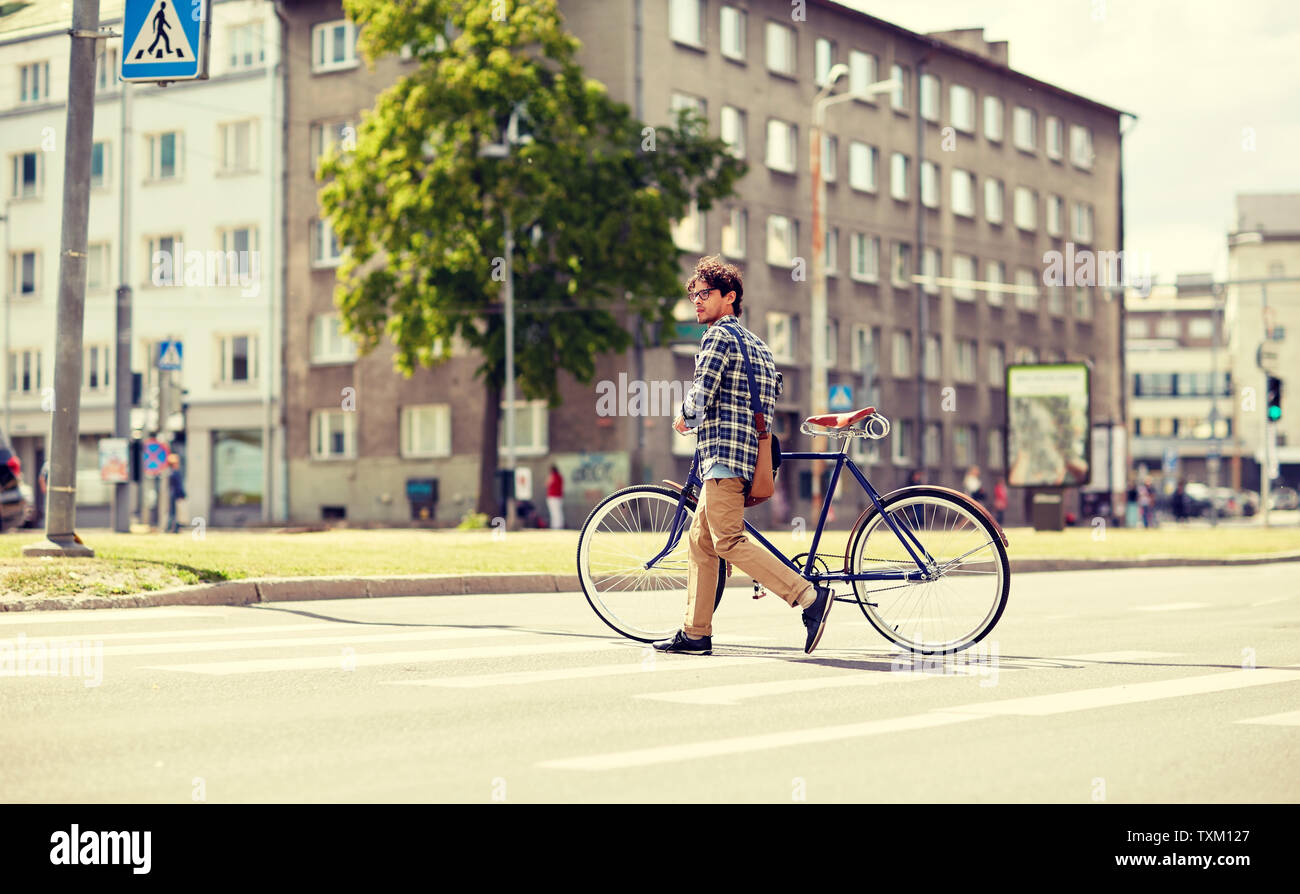 young man with fixed gear bicycle on crosswalk Stock Photo - Alamy