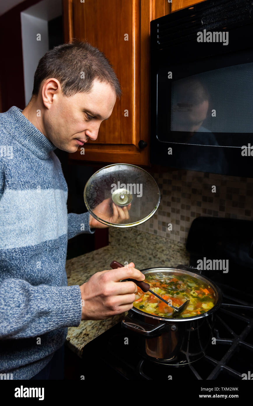 Man holding lid of pot hi-res stock photography and images - Alamy