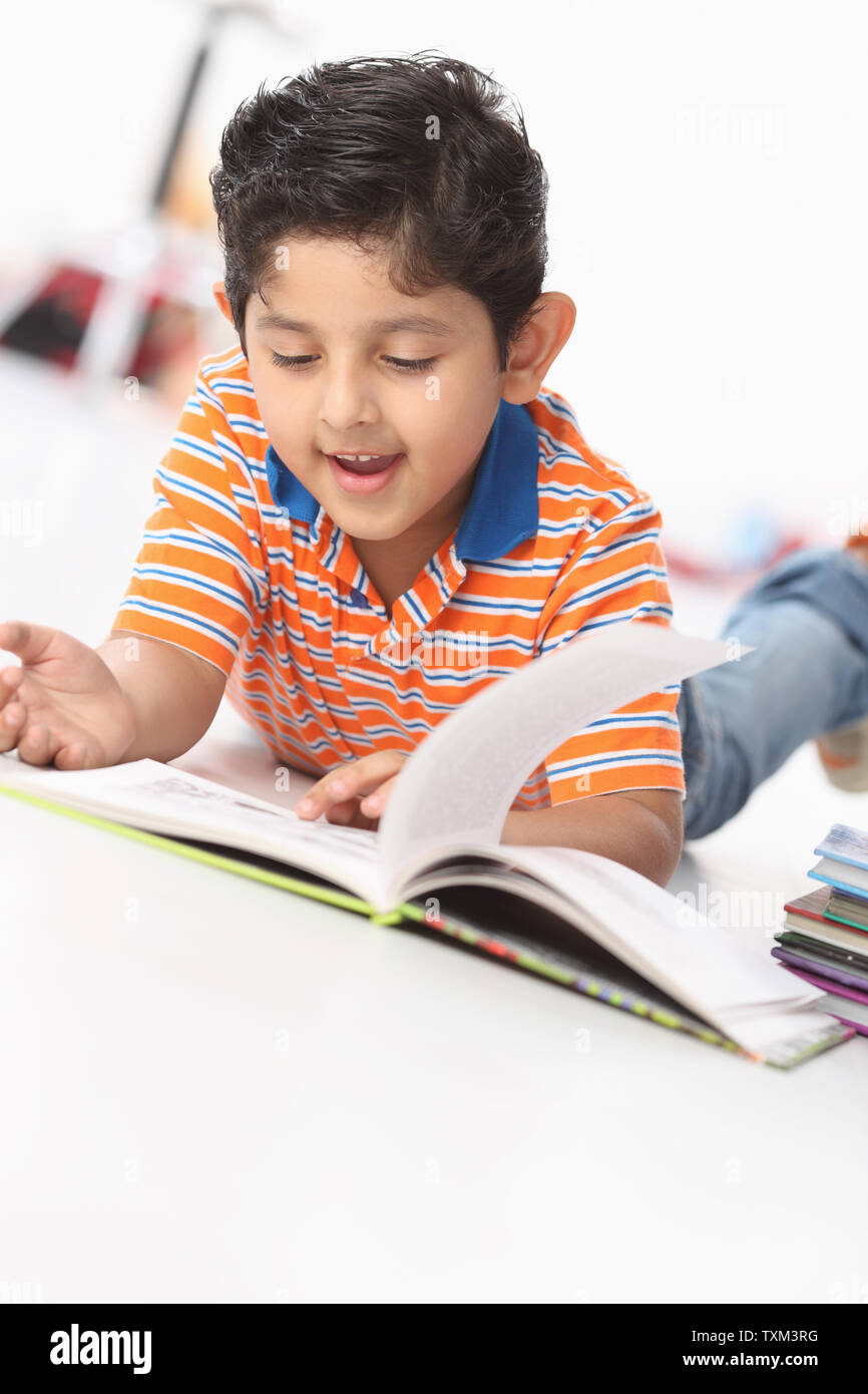 Boy reading a book Stock Photo - Alamy
