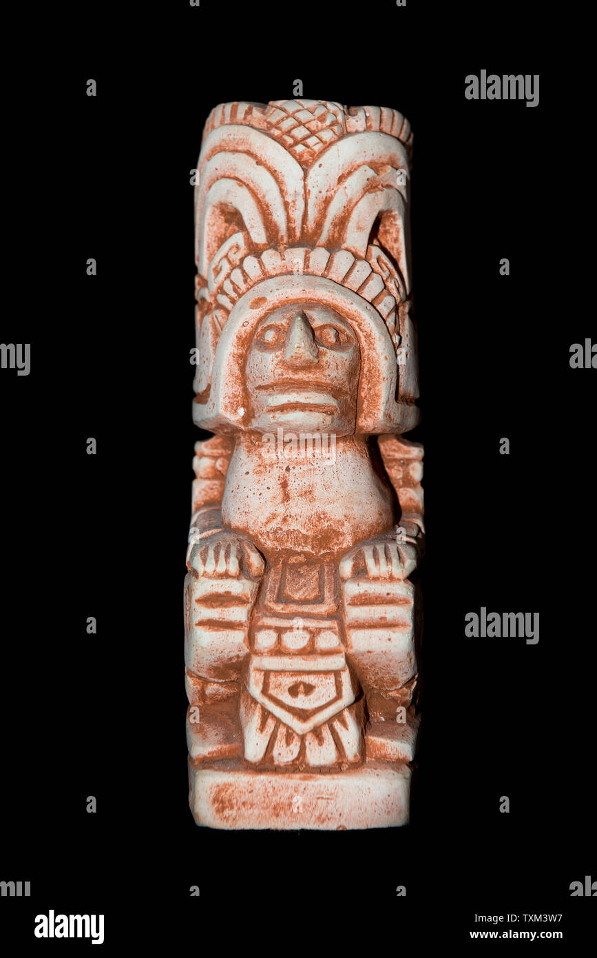 Mayan statue isolated against a black background Stock Photo - Alamy