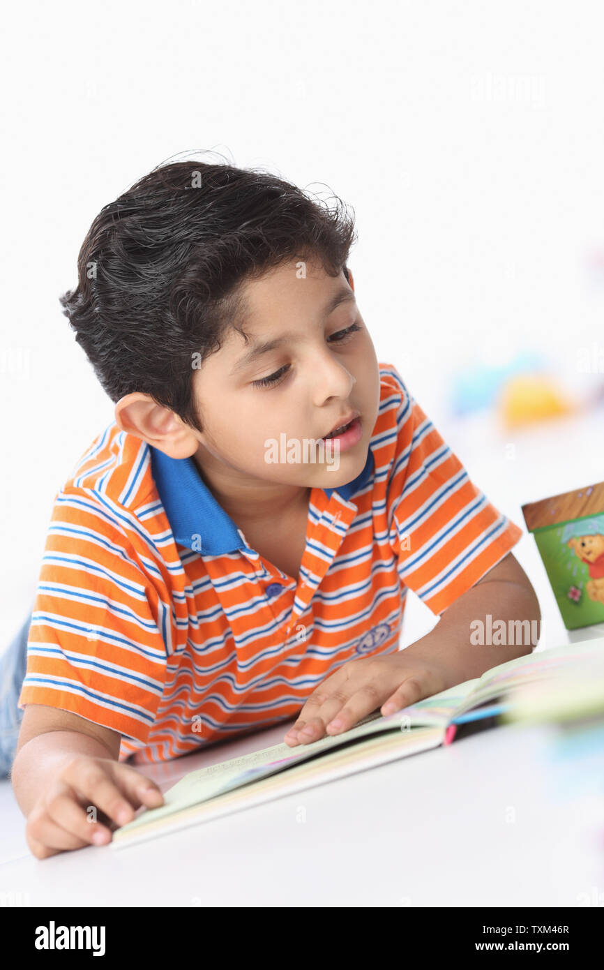 Boy reading a book Stock Photo - Alamy