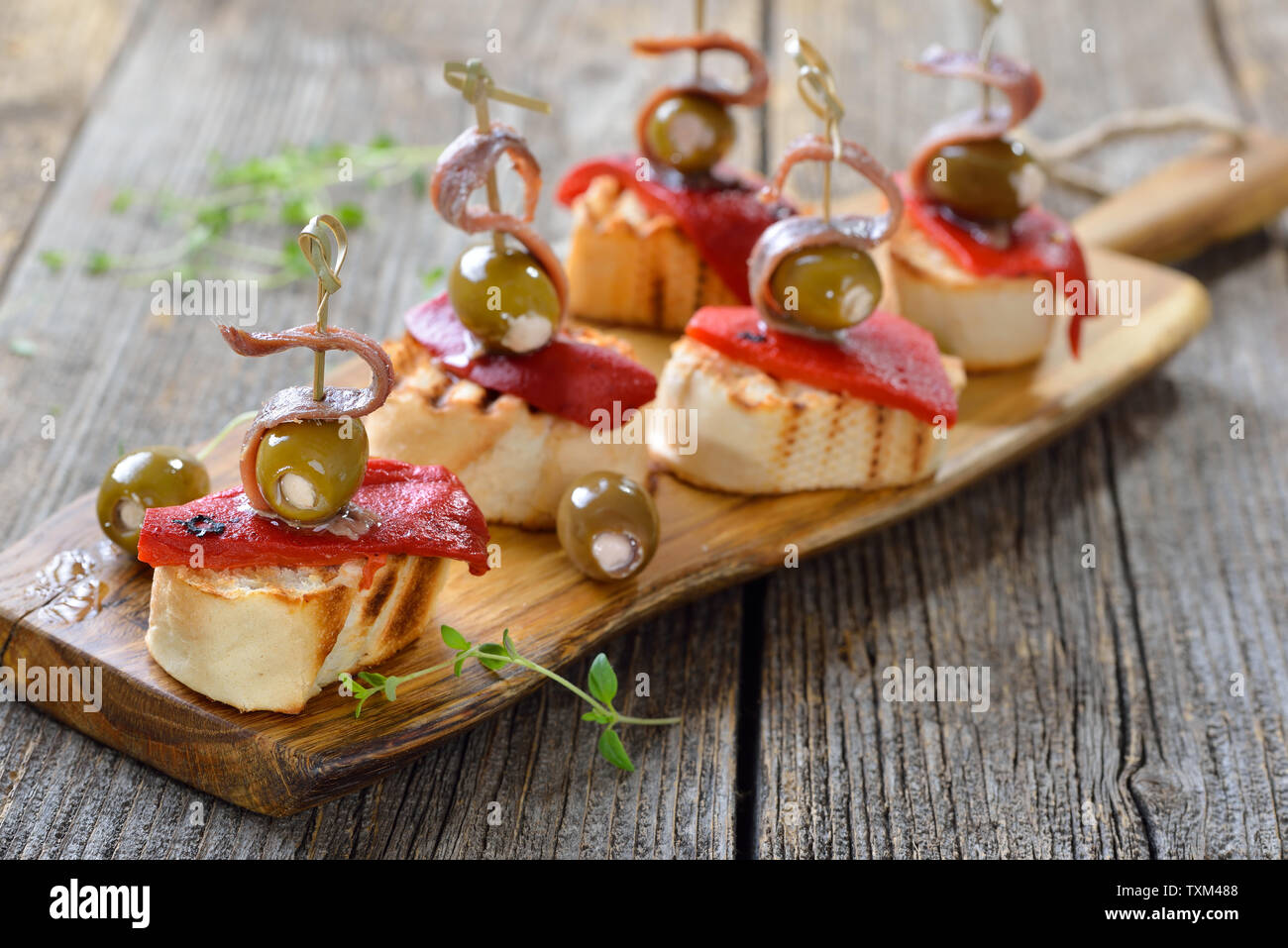 Spanish pinchos: Skewer snacks made of grilled bread with roasted and ...