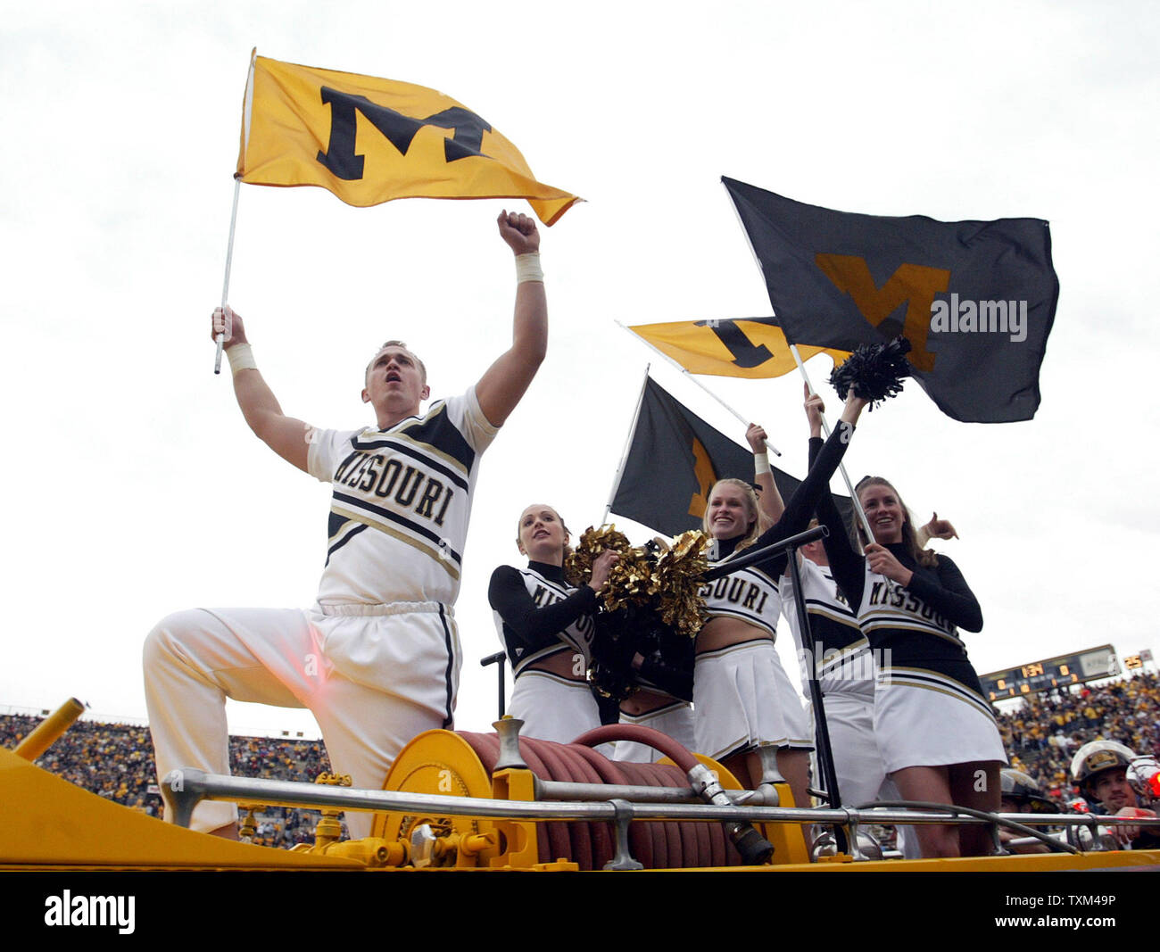 Missouri cheerleaders cheer atop a firetruck as the team takes to ...