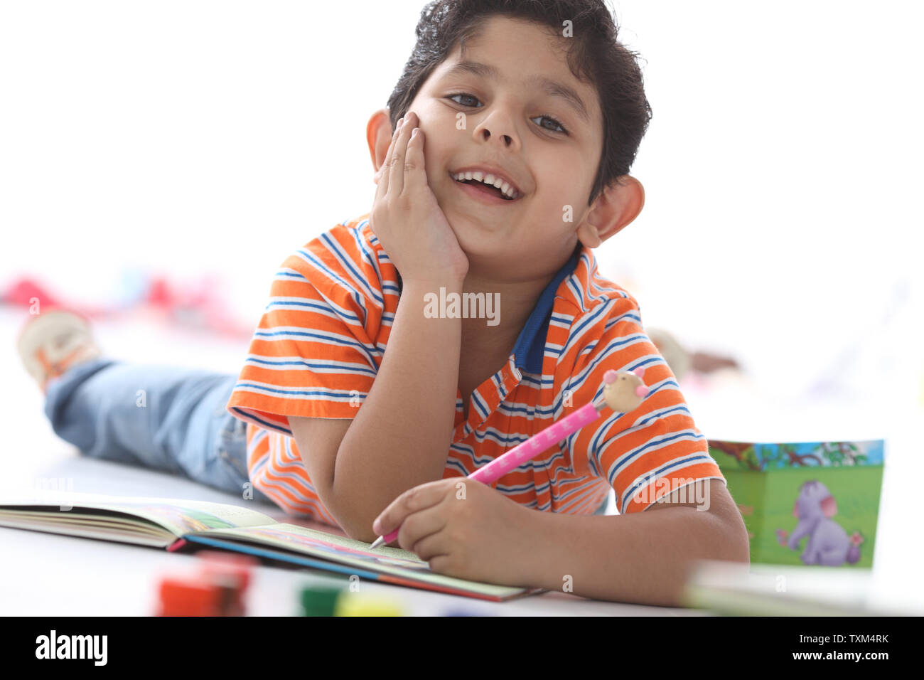 Boy lying front and writing hi-res stock photography and images - Alamy