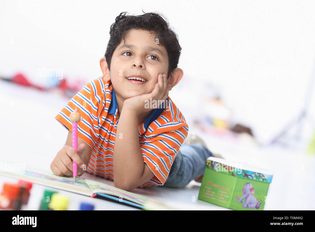 Boy lying front and writing hi-res stock photography and images - Alamy
