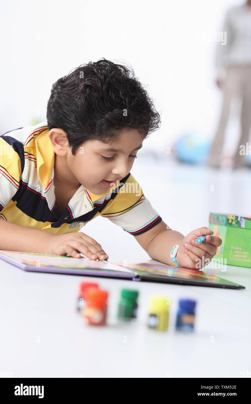 Boy coloring on a book Stock Photo - Alamy