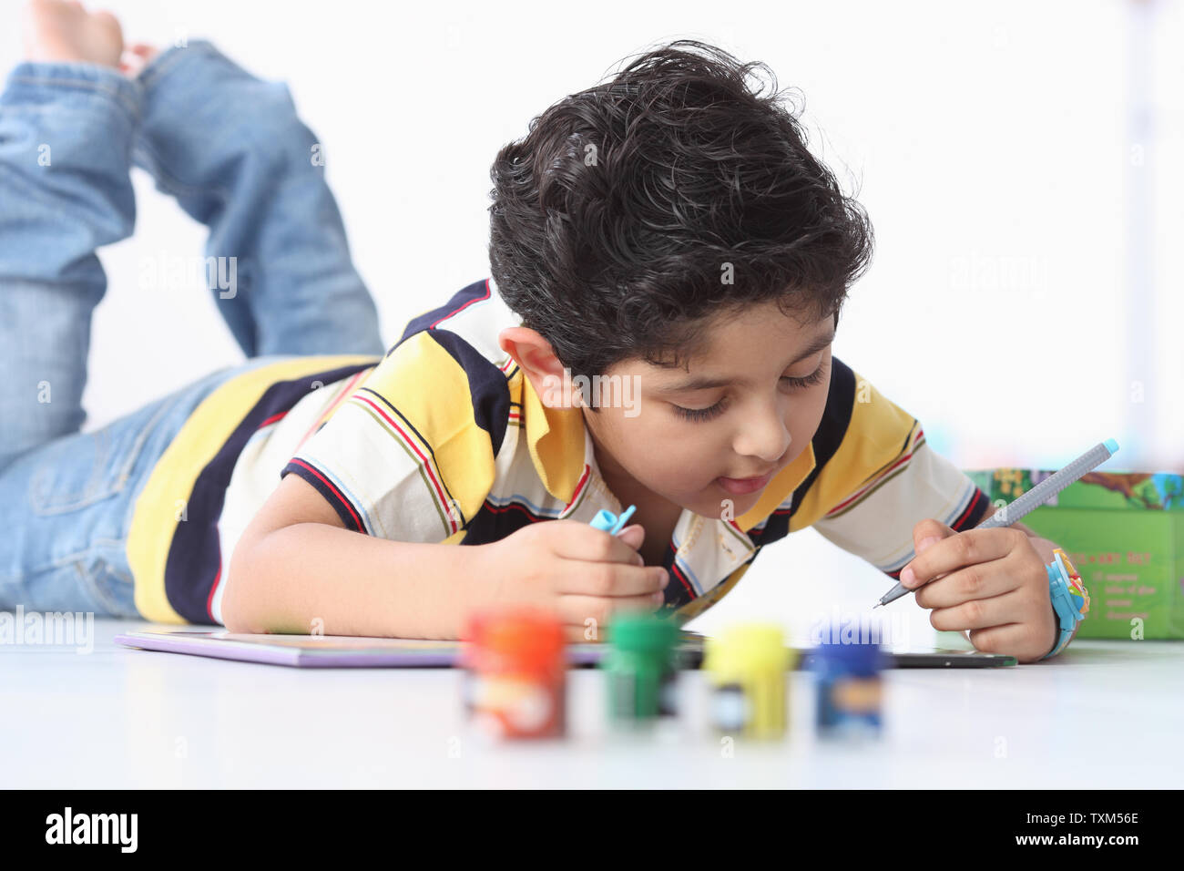 Boy coloring on a book Stock Photo - Alamy