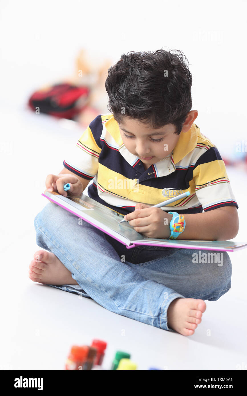Boy coloring on a book Stock Photo - Alamy