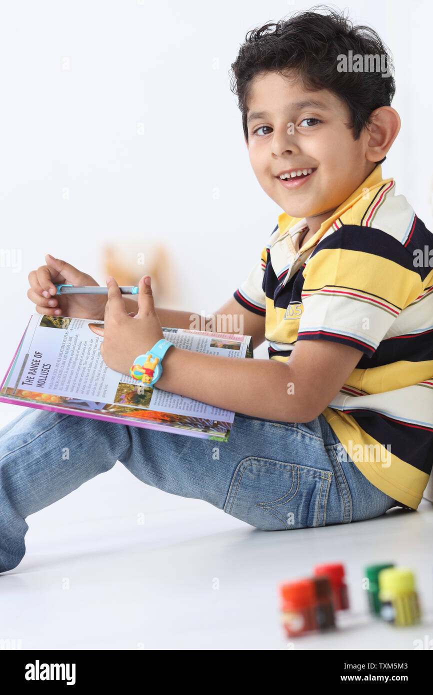 Boy coloring on a book Stock Photo - Alamy