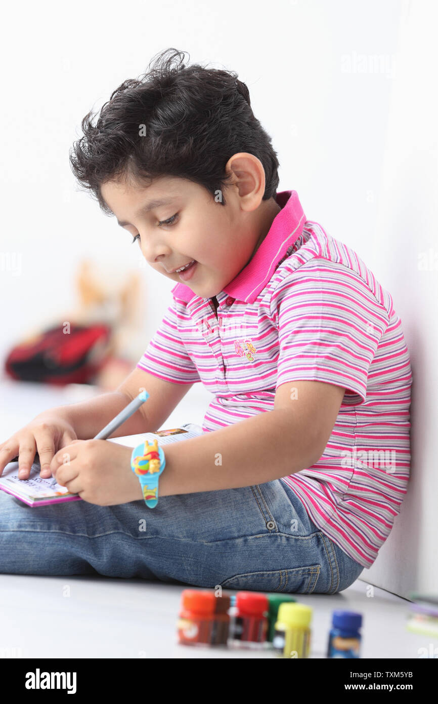 Boy coloring on a book Stock Photo - Alamy
