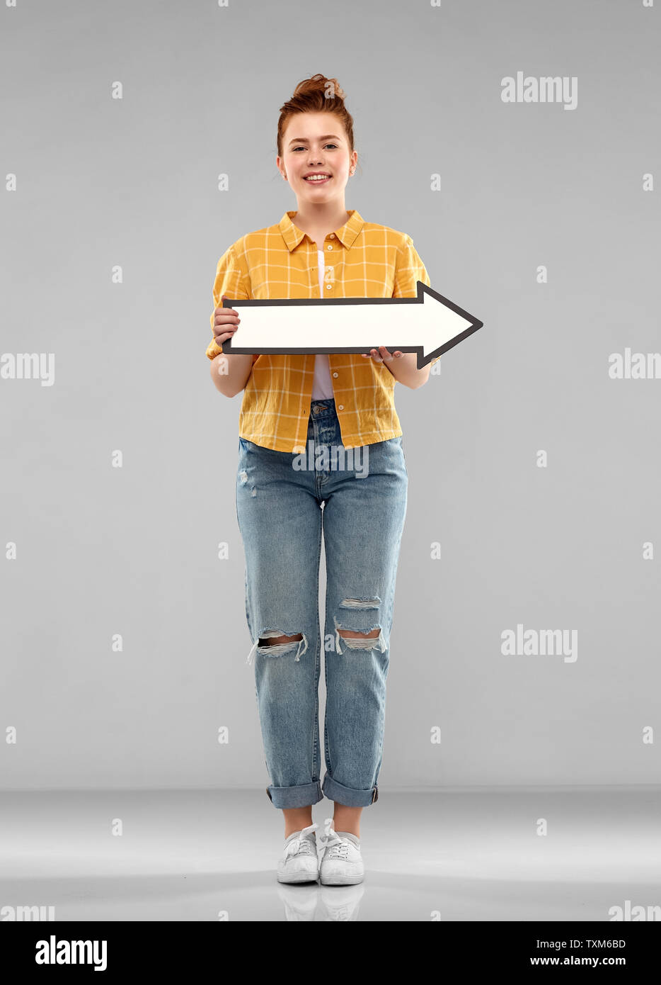 redhead teenage girl with arrow showing to right Stock Photo - Alamy