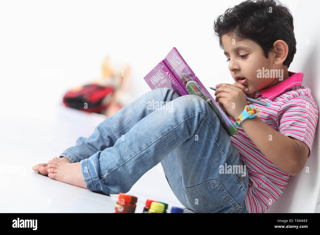 Boy coloring on a book Stock Photo - Alamy