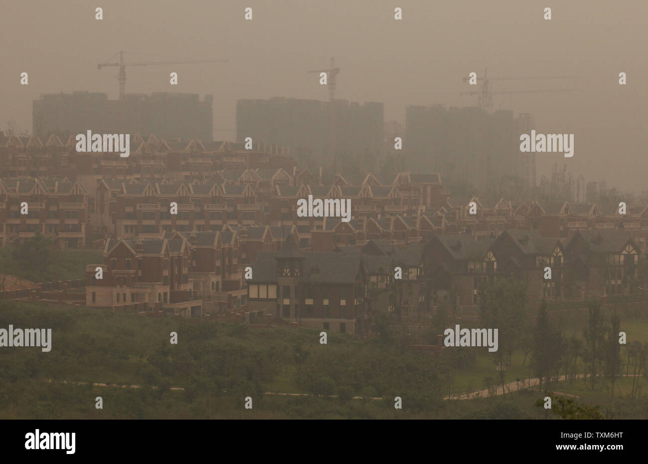 Heavy pollution hangs over a new, upscale housing estate and country ...