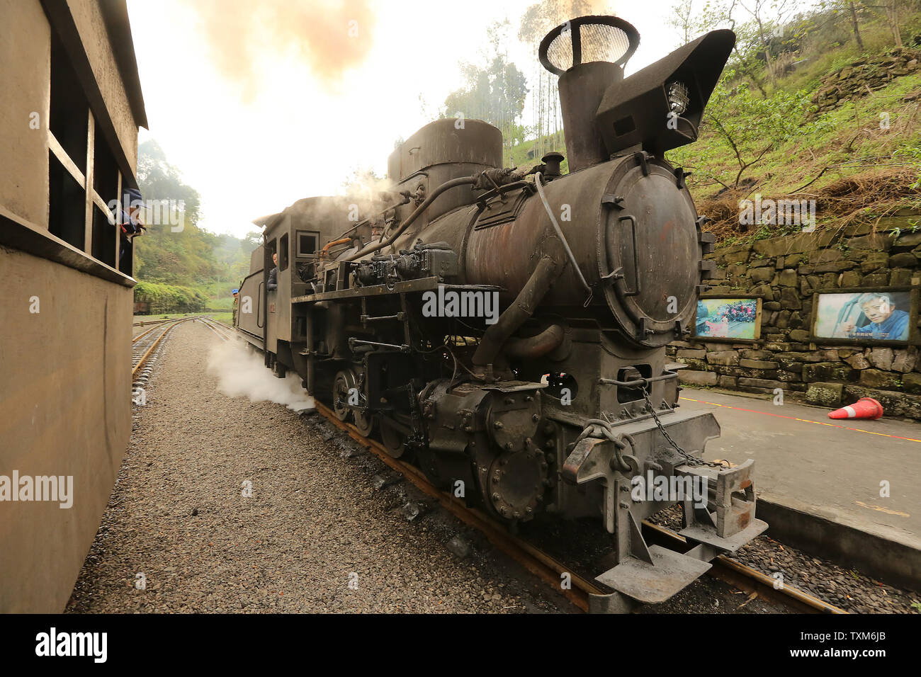 An old steam train arrives to hitch up to passenger carriages near ...