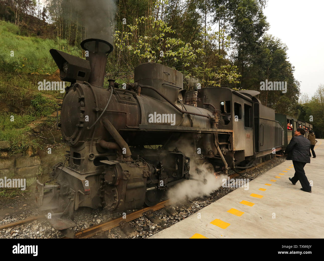 An locomotive engineer checks out his engine at a train stop near ...