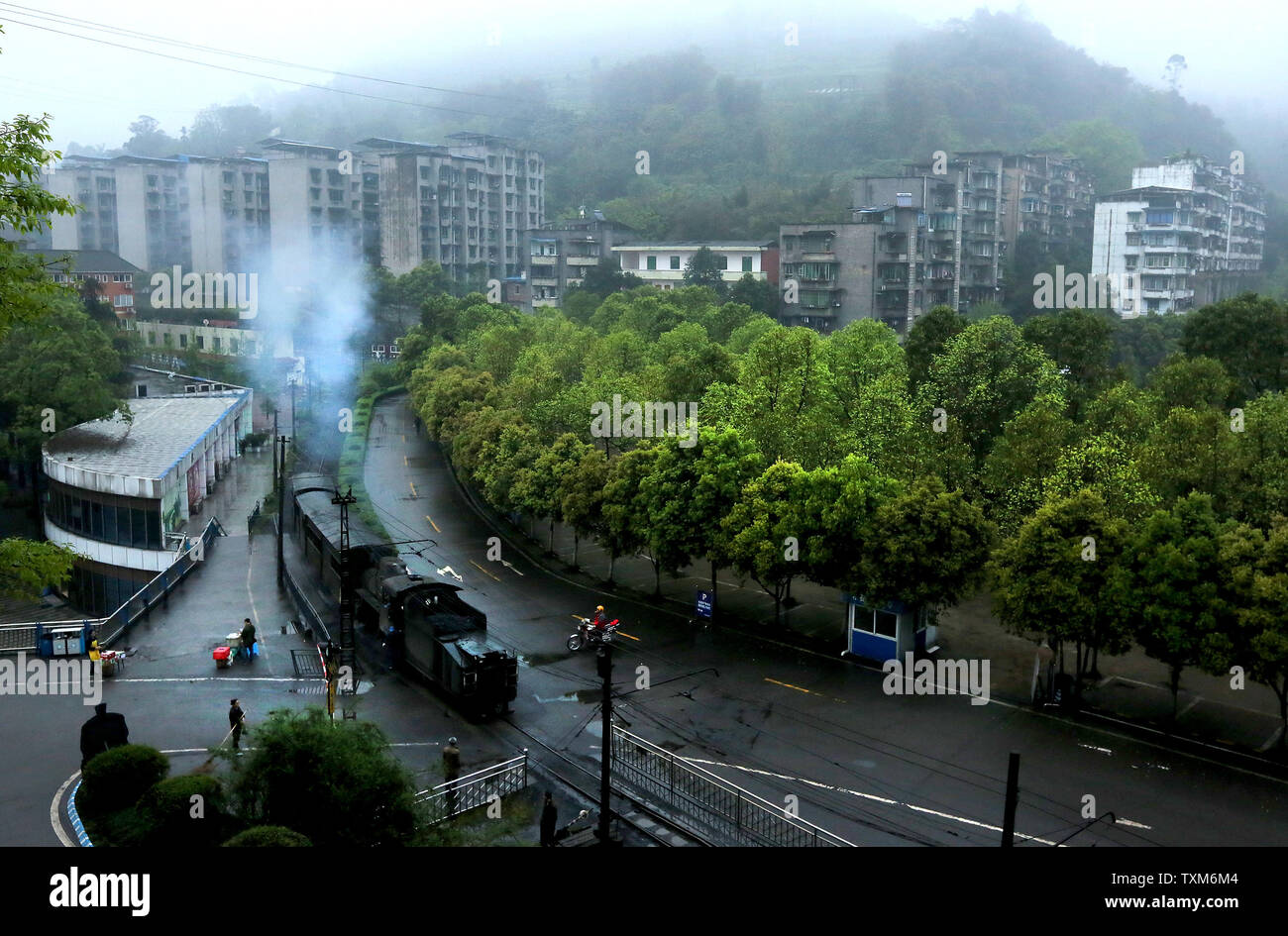 A passenger steam train arrives at the Yuejin station in Jiayang, a ...