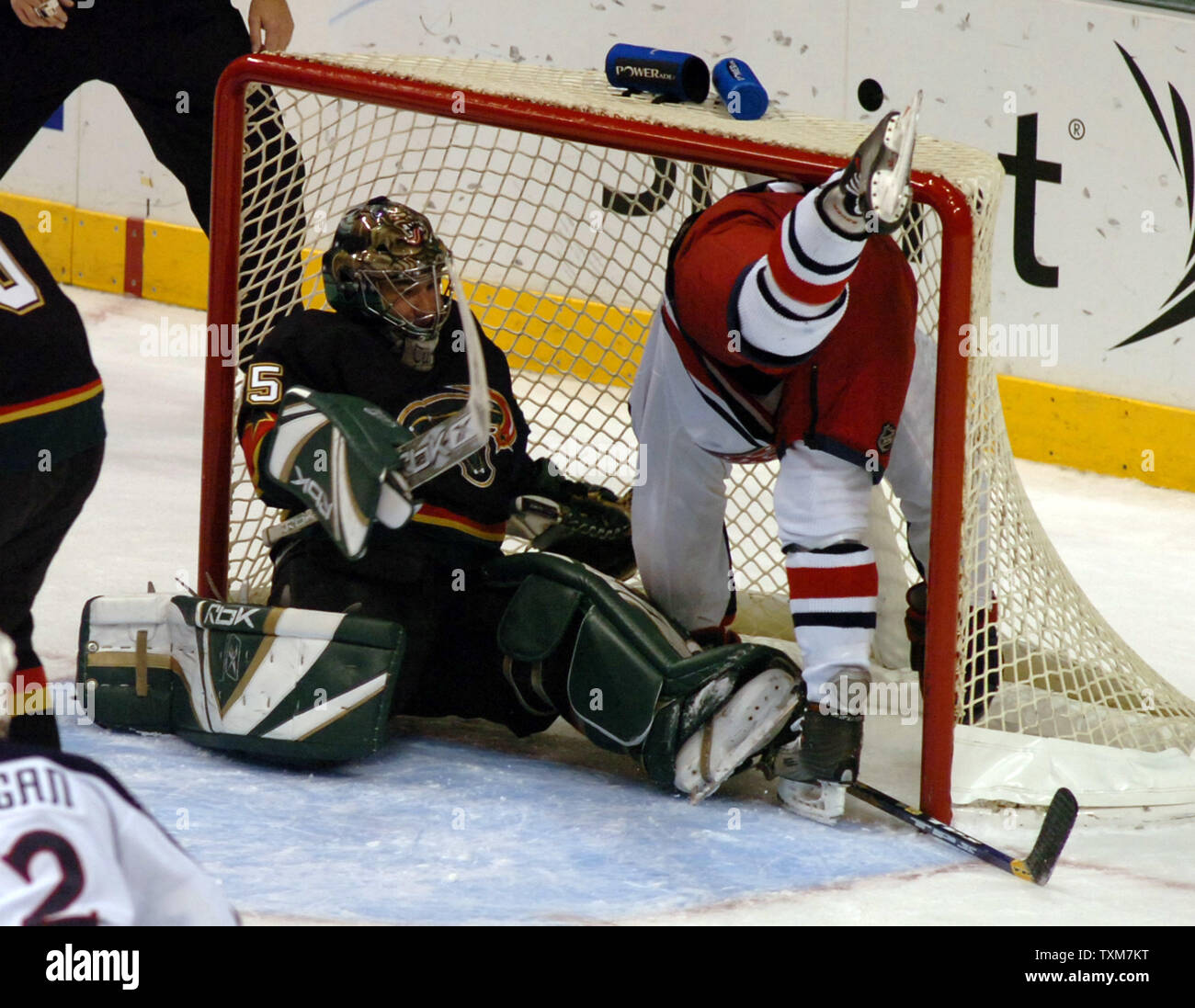 Columbus's Dan Fritsche falls headfirst into the Dallas net as goalie ...