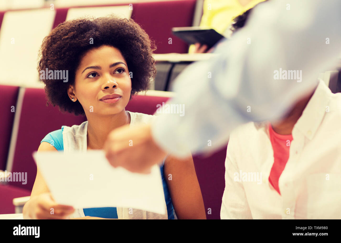 teacher giving test to student girl on lecture Stock Photo - Alamy