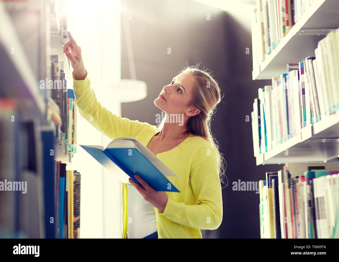 high school student girl reading book at library Stock Photo - Alamy