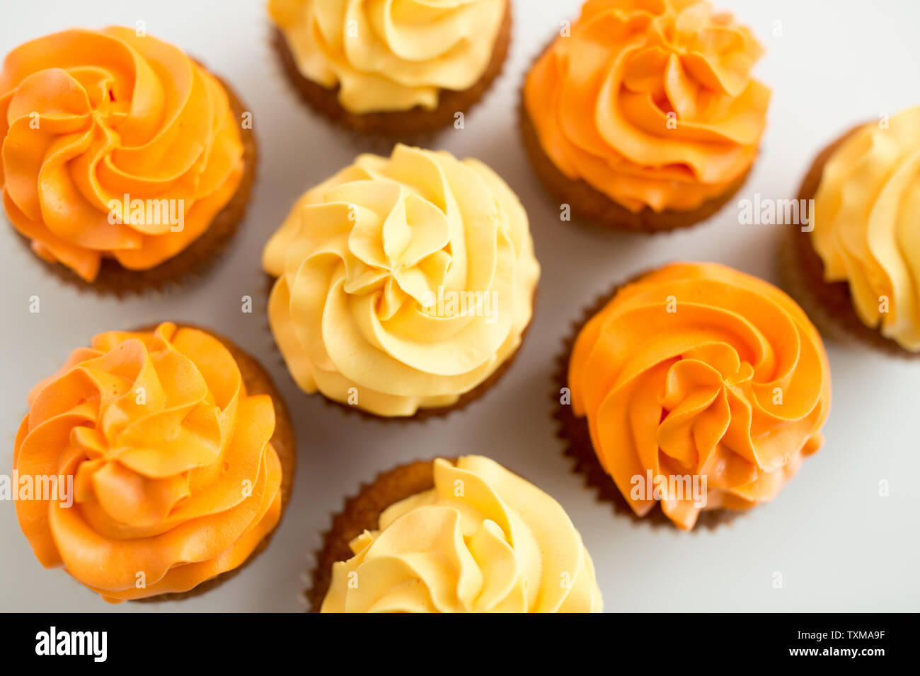cupcakes with frosting on white background Stock Photo - Alamy