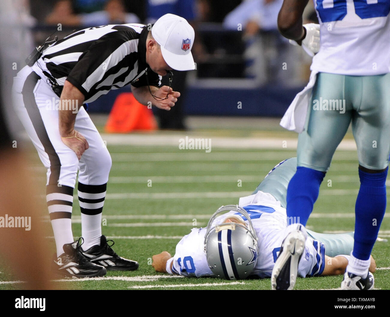 Referee John Parry checks on injured quarterback Tony Romo during the ...