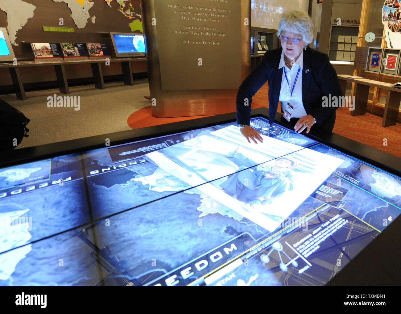 Docent Patricia Flynn uses the Defending Freedom Table, one of the ...