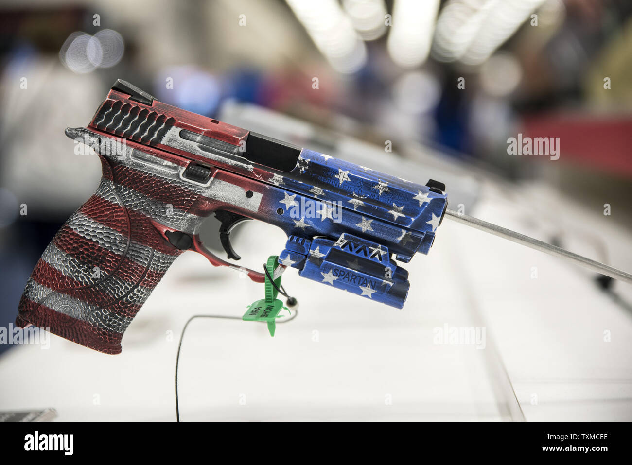 A gun painted like the American flag is displayed inside the exhibition ...