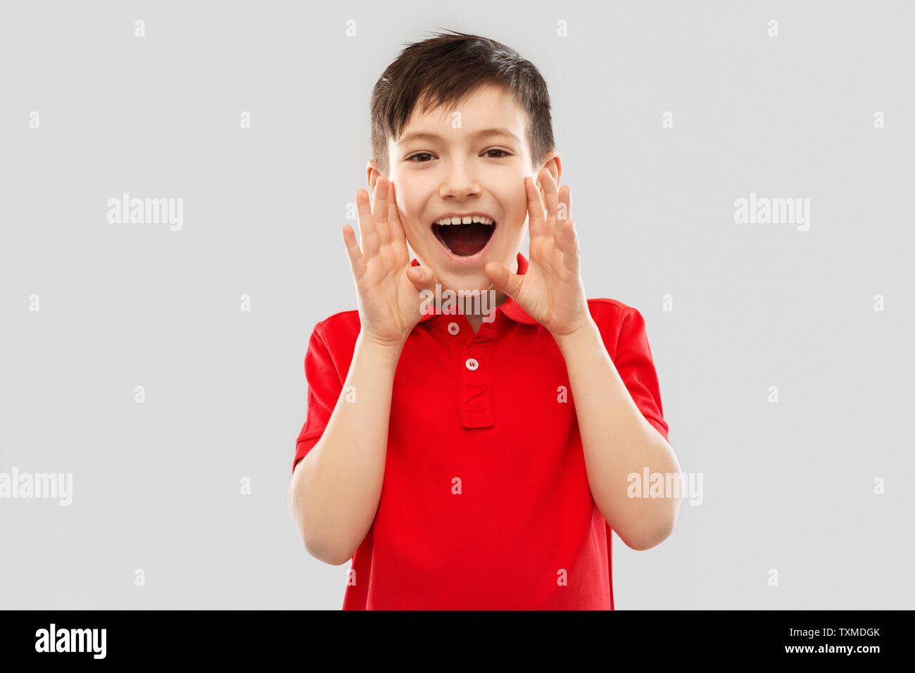 boy in red polo t-shirt shouting or calling Stock Photo - Alamy