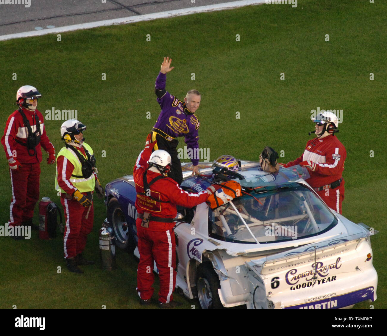 Mark Martin waves to the crowd after emerging from his wrecked car ...