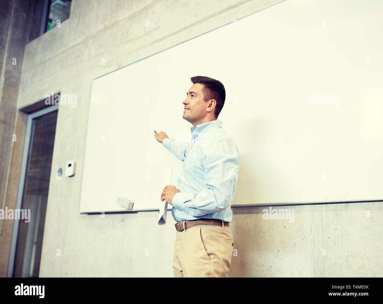 teacher pointing marker to white board at lecture Stock Photo - Alamy