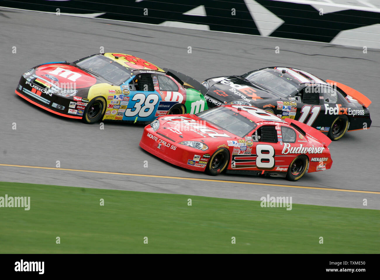Dale Earnhardt Jr (8) passes David Gilliland (38) and Denny Hamlin (11 ...