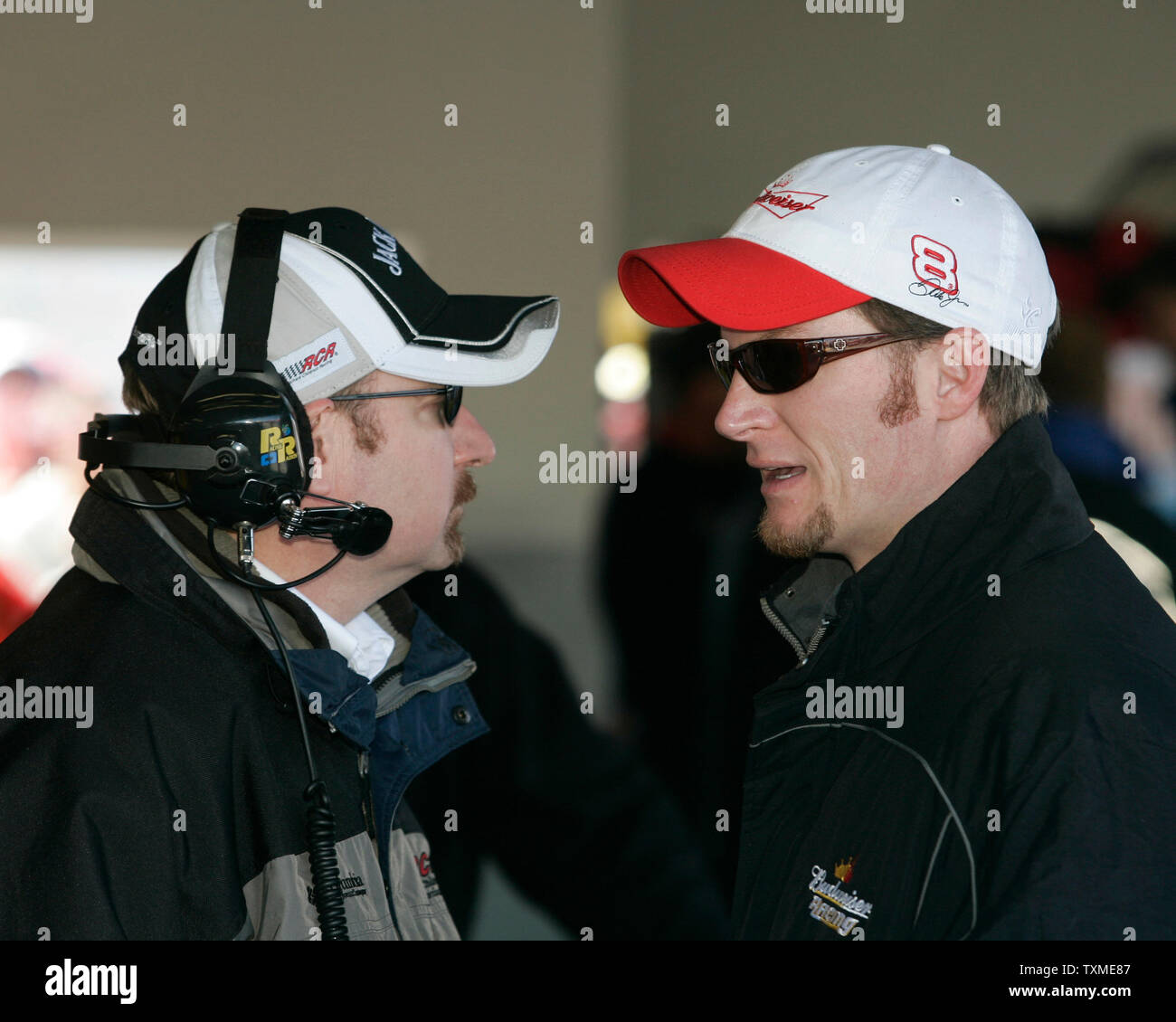 Dale Earnhardt Jr. (R) talks with Bobby Hutchens in his garage during ...