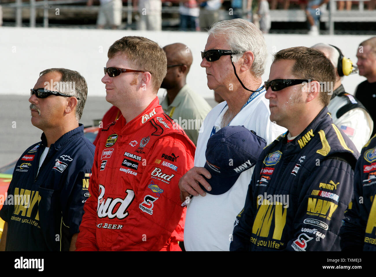 Dale Earnhardt Jr. (2nd L) and crew listen to the National Anthem on ...