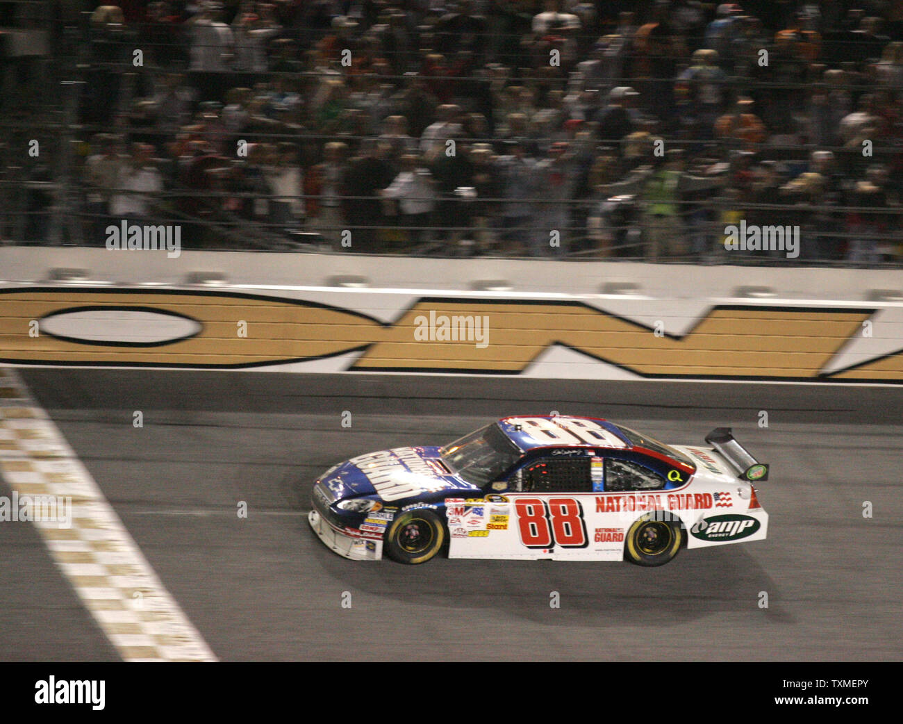 Dale Earnhardt Jr. crosses the finish line winning the NASCAR Budweiser ...