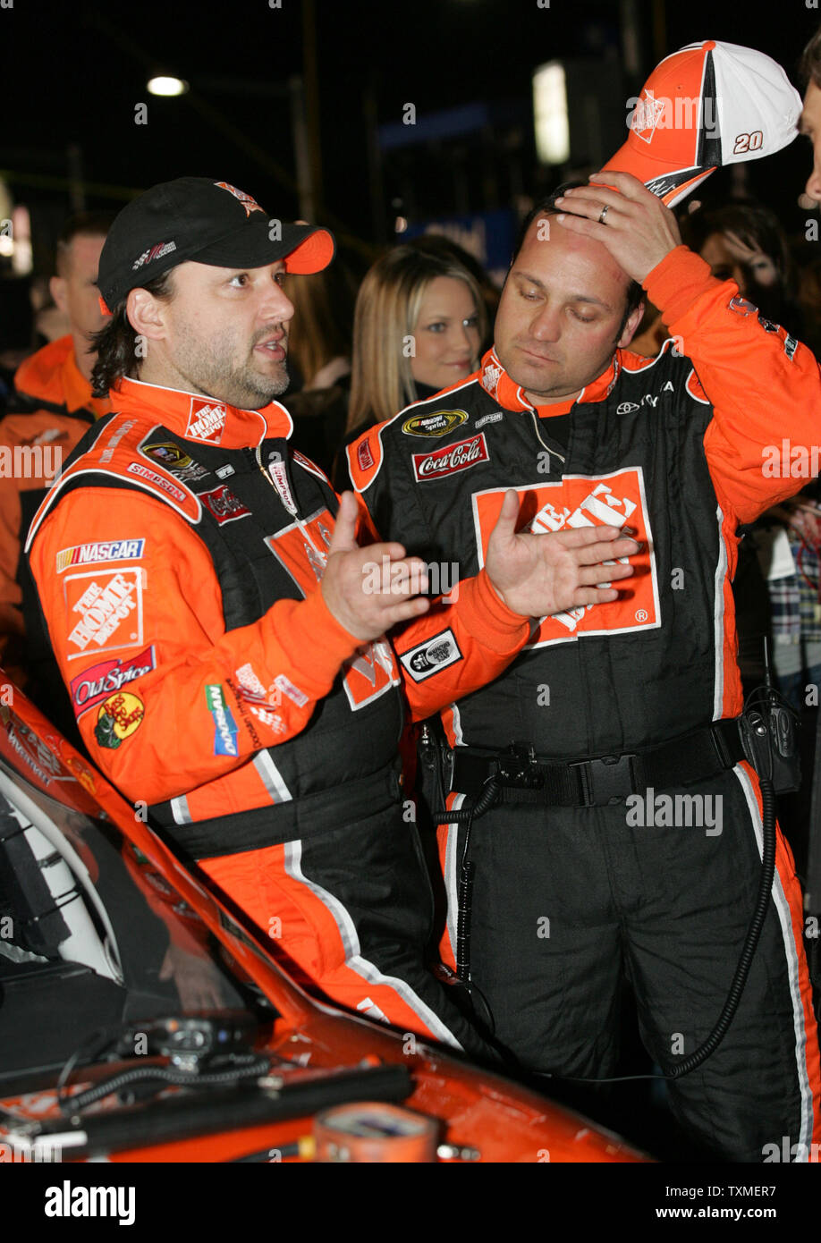 Tony Stewart (L) and his crew chief Greg Zipadelli wait on pit road for ...