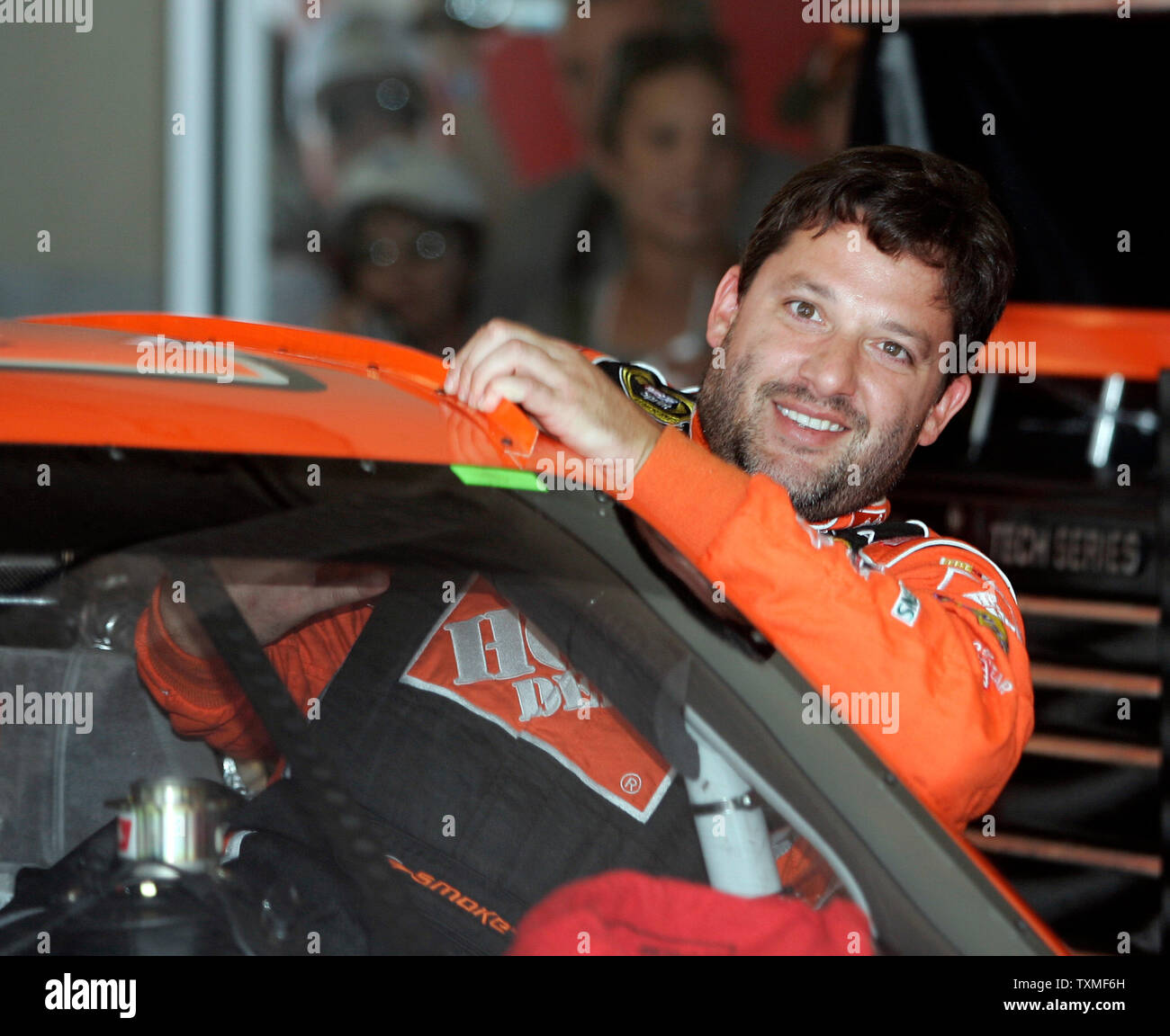 Tony Stewart climbs in his car prior to the NASCAR Sprint Cup Coke Zero ...