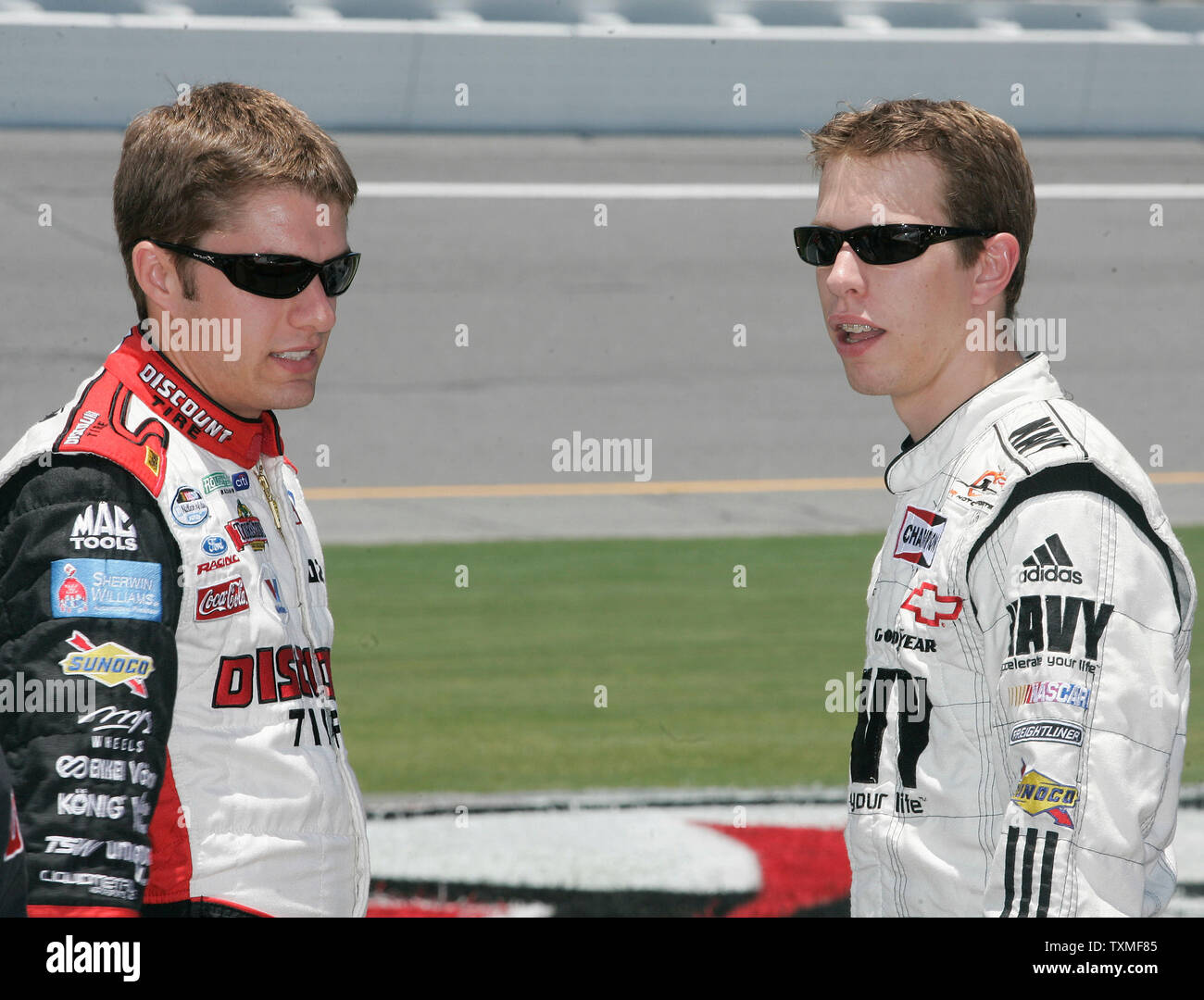 Brad Keselowski (R) and David Ragan wait on pit road for their turn to ...