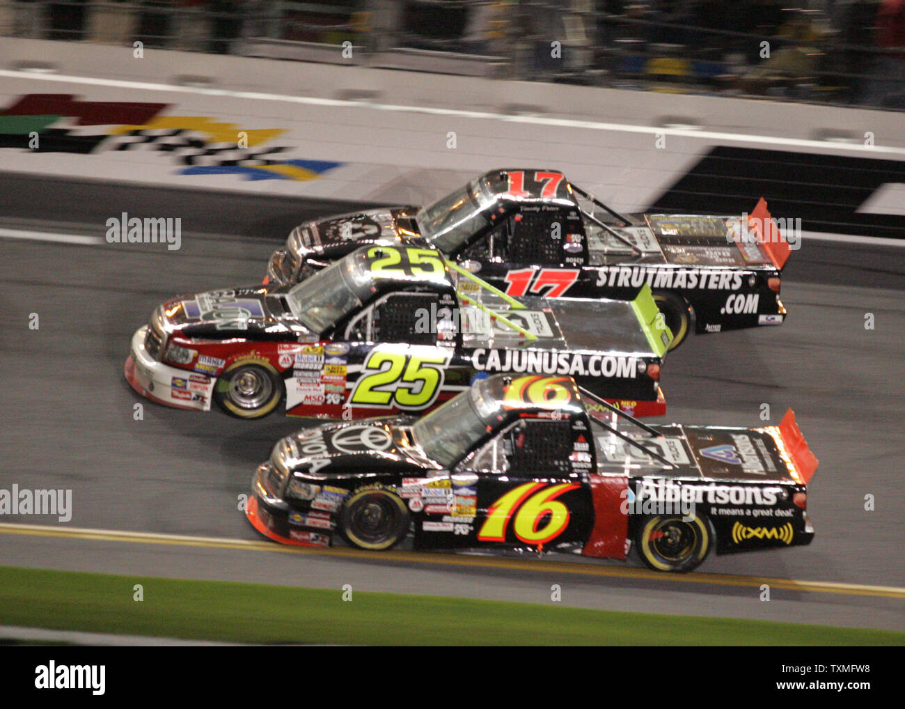 Brian Scott (16), Terry Cook (25) and TimPeters (17) run three wide on ...