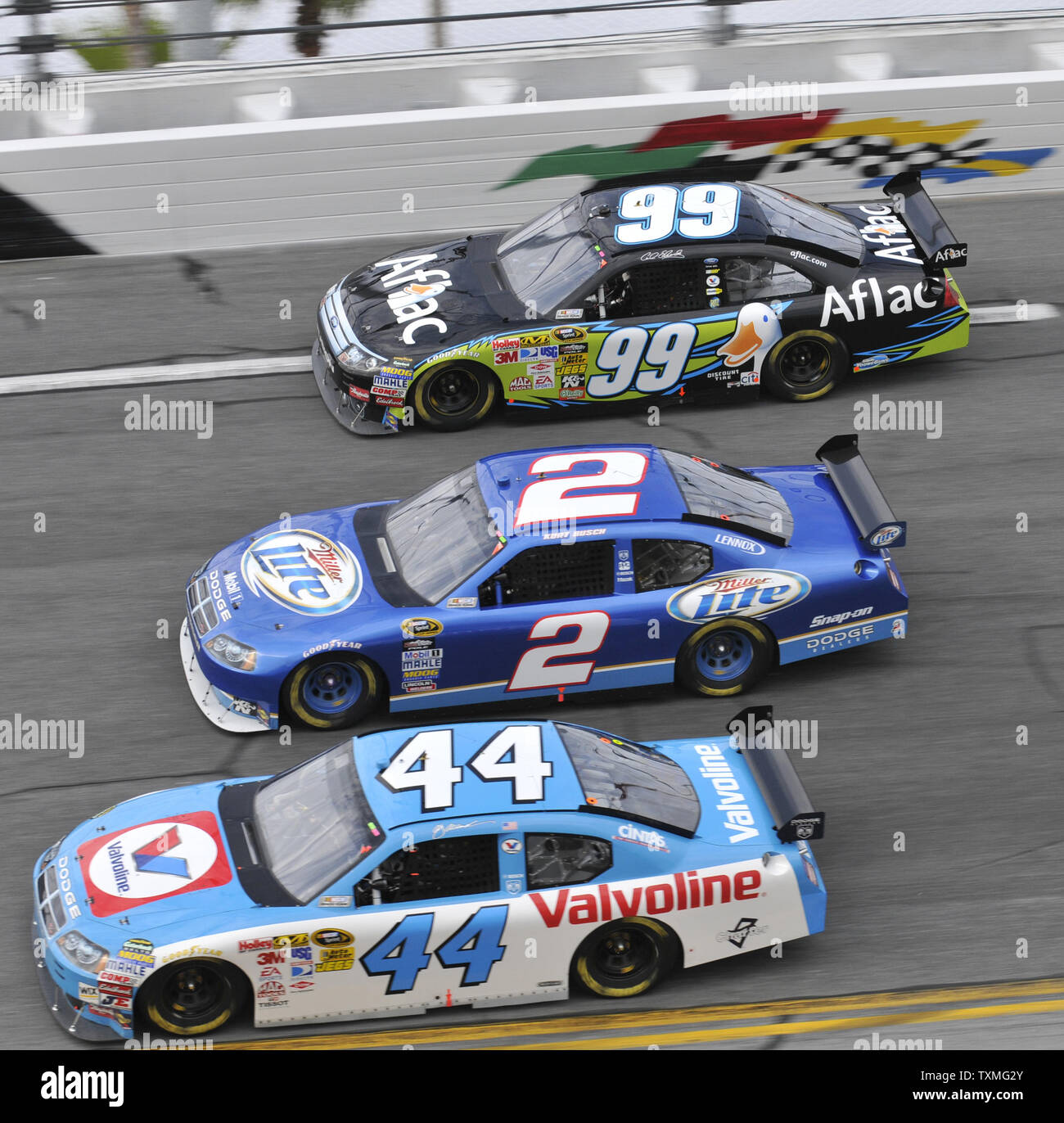 AJ Allmendinger (44), Kurt Busch (2), and Carl Edwards (99) run three ...