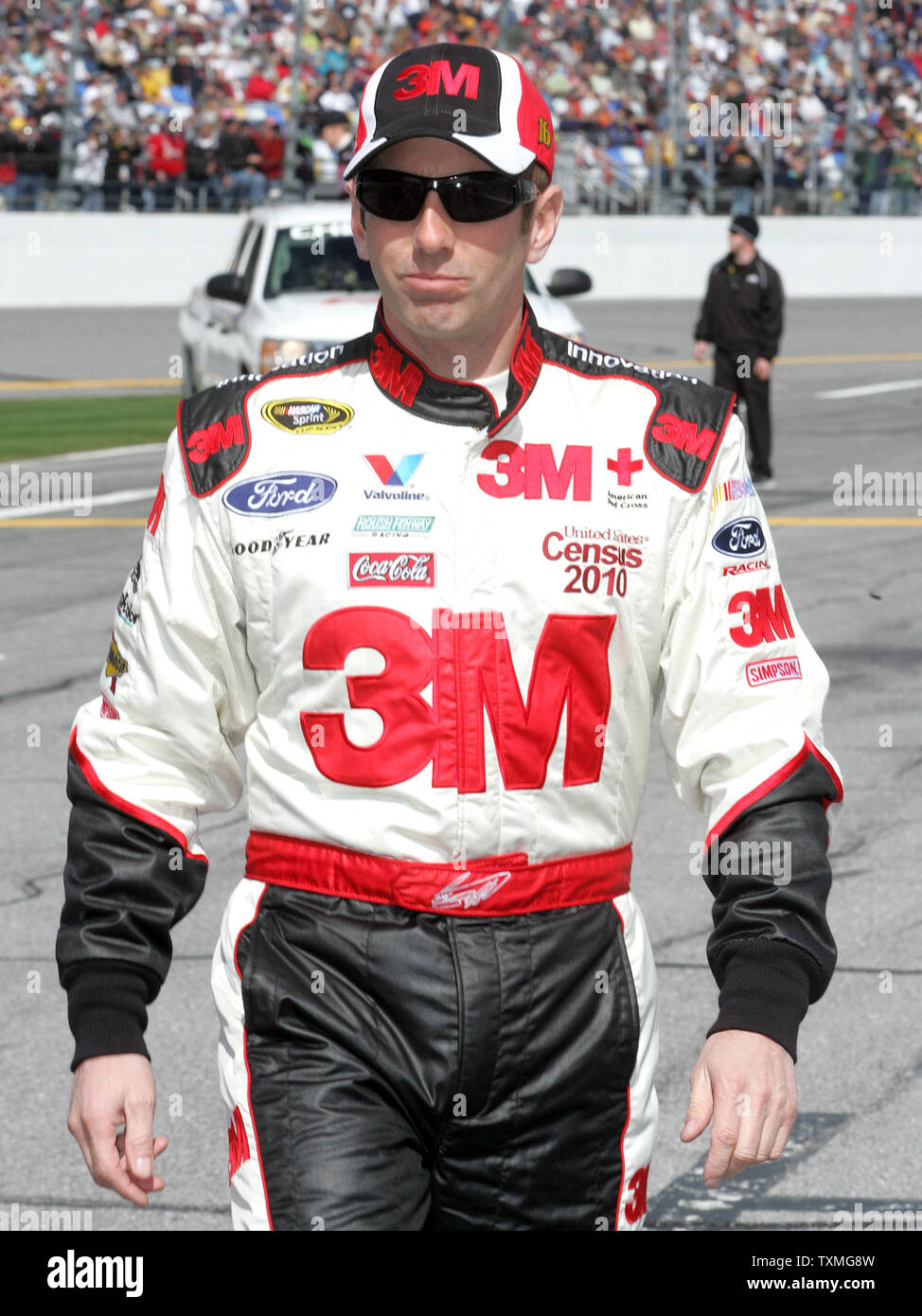 Greg Biffle walks down pit road to his car for the start of the NASCAR ...