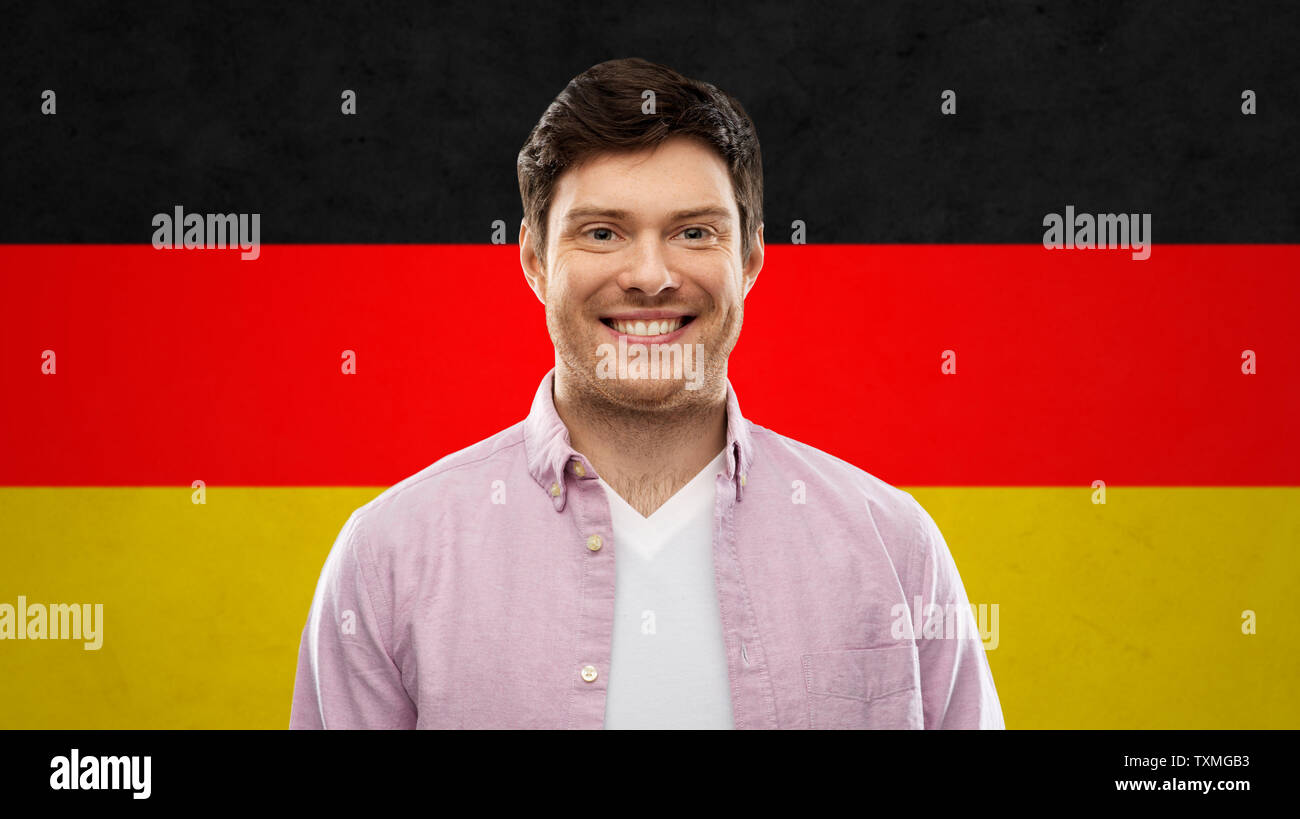 smiling young man over german flag colors Stock Photo - Alamy