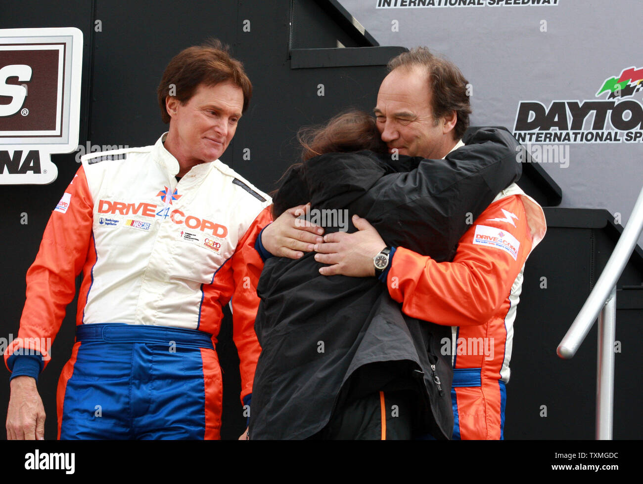 Danica Patrick (C) hugs Jim Belushi as Bruce Jenner watches, at driver ...