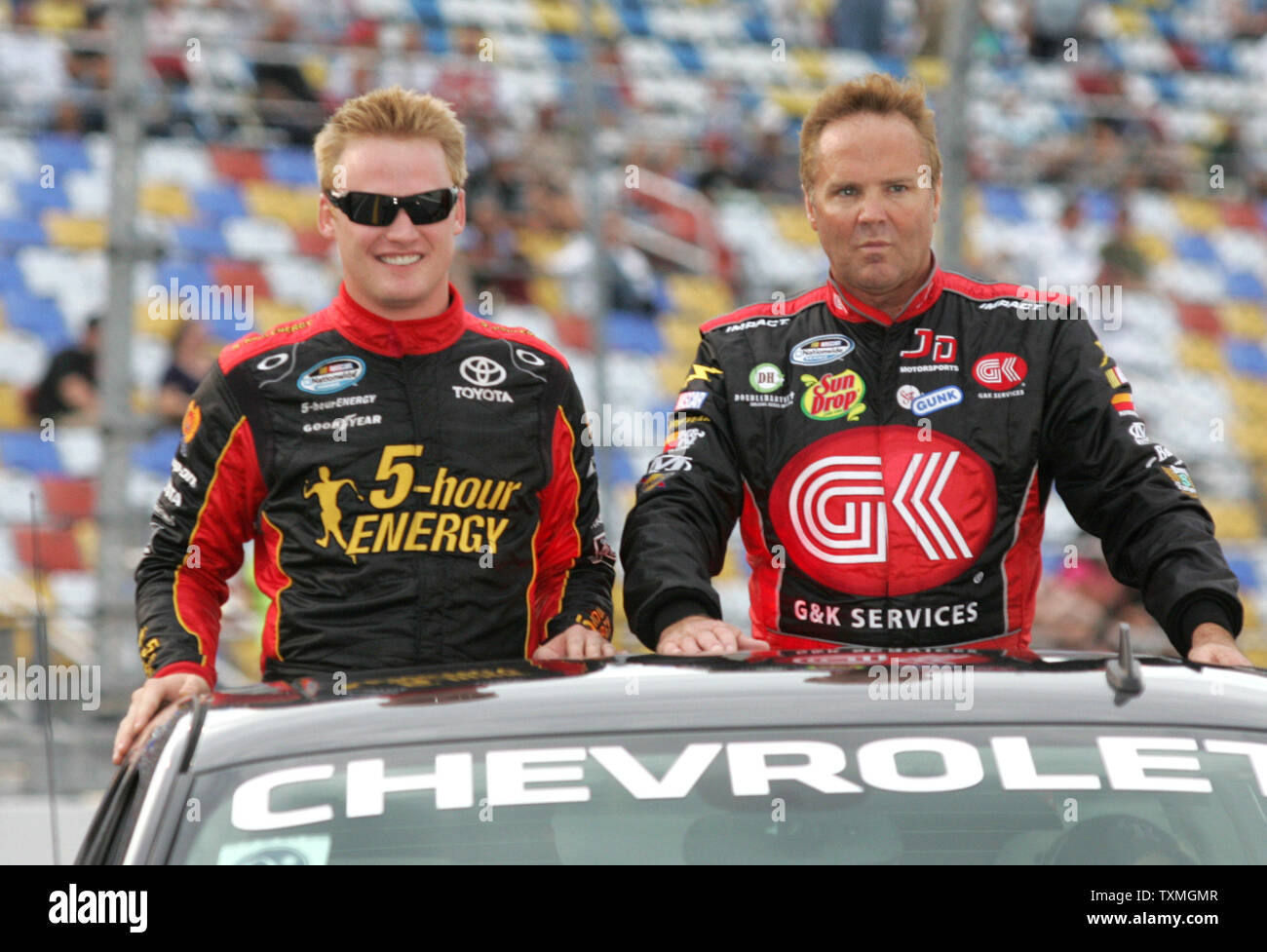 Steve Wallace (L) and his uncle Michael Wallace are driven to pit road ...