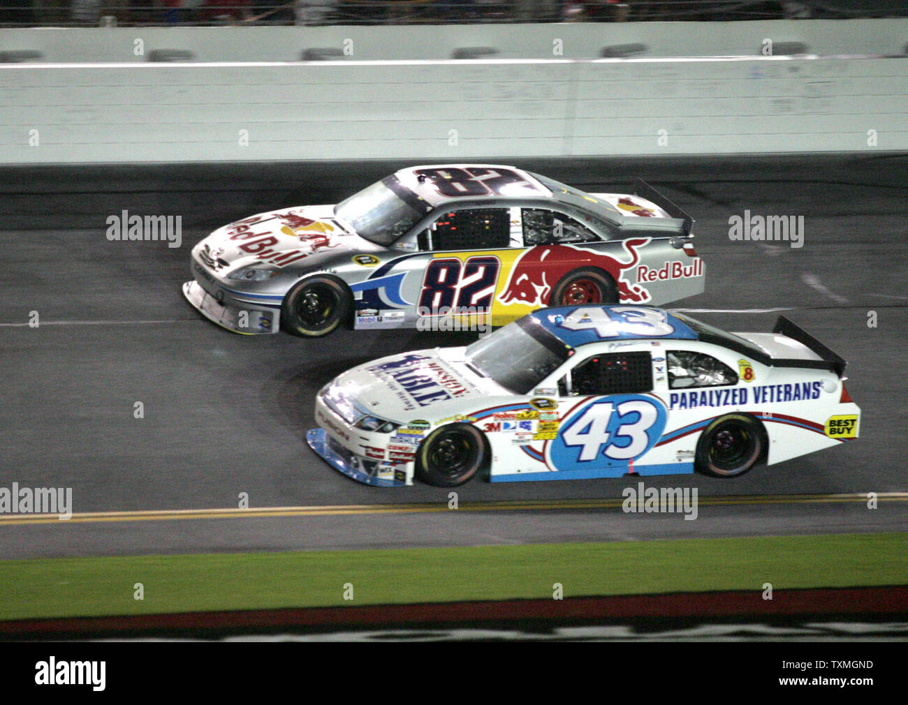 AJ Allmendinger (43) passes Scott Speed (82) on the front stretch ...